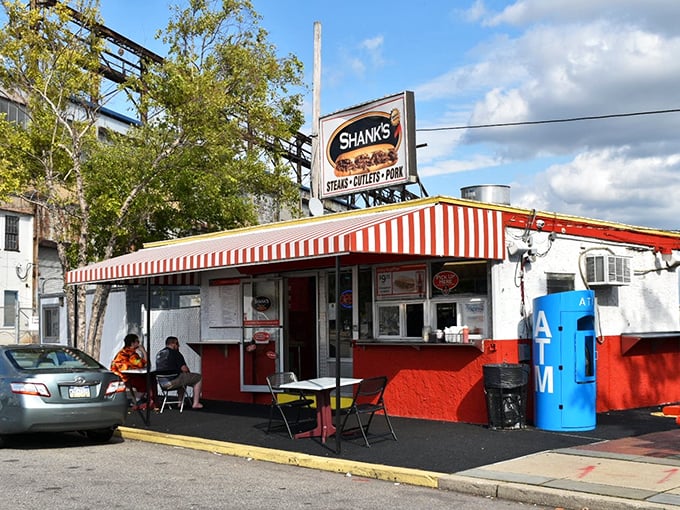 The red and white awning isn't just decoration—it's a beacon of hope for the cheesesteak-deprived masses of Philadelphia's waterfront.