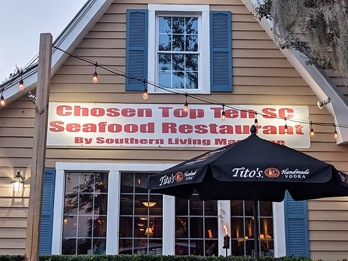 The modest façade of Lee's Inlet Kitchen proudly glows beneath its banner, a true South Carolina gem where top-ten seafood status speaks louder than appearances.