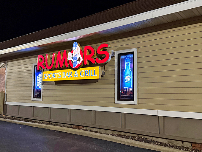 The neon glow of Rumors' sign serves as a beacon for hungry travelers, promising cold drinks and that legendary Wisconsin lobster bisque within.