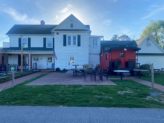 The Farmhouse welcomes you with classic white clapboard charm and a patio where string lights twinkle like stars over your evening feast.