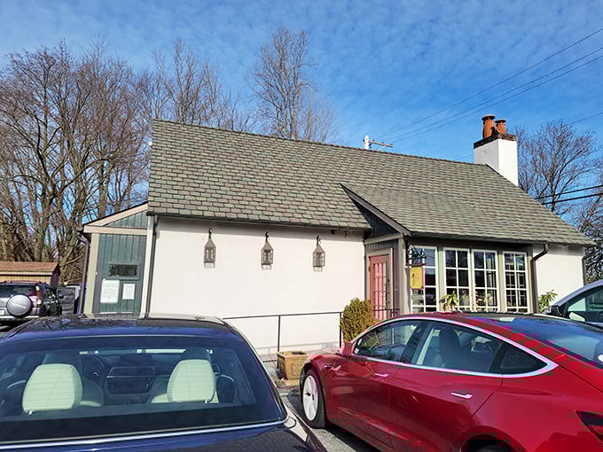 The quintessential British countryside escape, transported brick by brick to Pennsylvania's rolling hills. This charming white cottage promises authentic flavors within its unassuming walls.