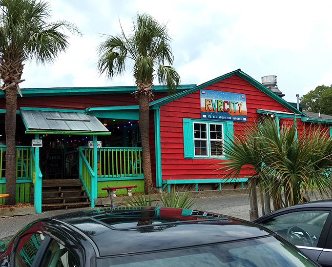 The coral-pink exterior with turquoise trim isn't just a building—it's a mood announcement. Beach vibes and burger dreams await!