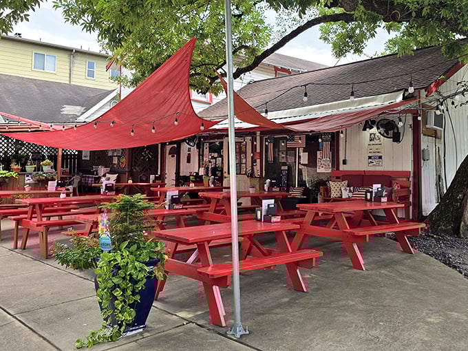 Those vibrant red picnic tables aren't just furniture—they're Houston's version of the red carpet, inviting you to the best burger show in town.