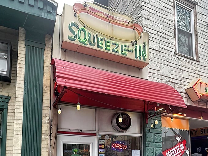 The iconic turquoise storefront beckons with its vintage neon arrow. At The Squeeze-In, the name isn't just clever marketing—it's a literal description.