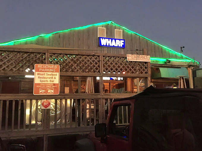After sunset, The Wharf transforms with emerald lights, beckoning hungry travelers like a neon-trimmed lighthouse for seafood pilgrims.