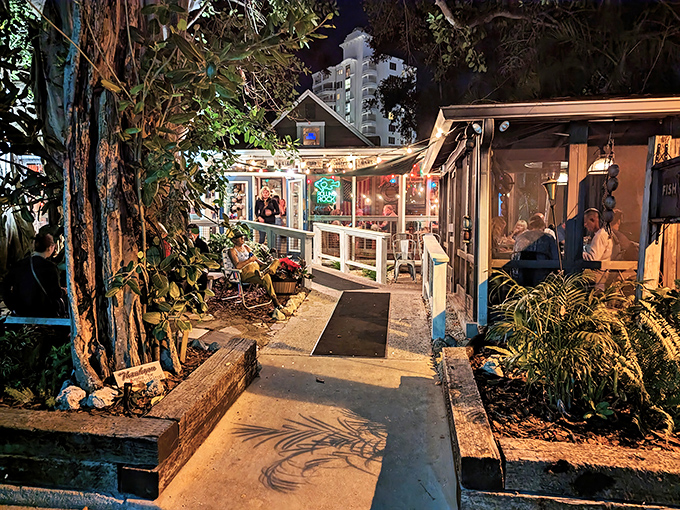 The enchanted pathway to Owen's Fish Camp, where lush Florida foliage and twinkling lights welcome seafood pilgrims to paradise.