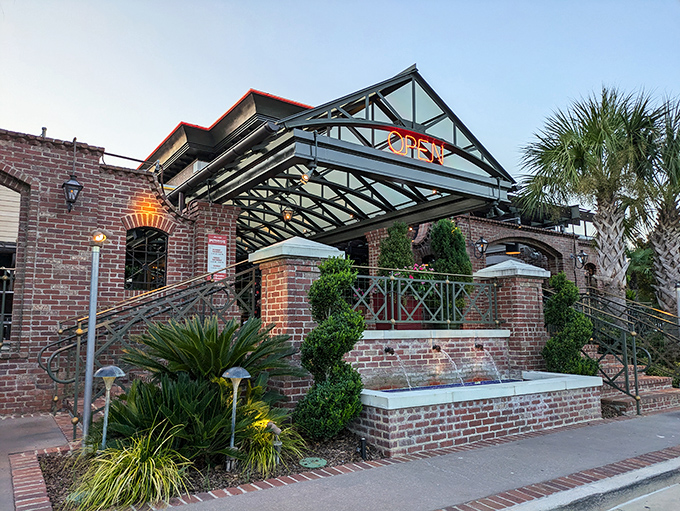 The grand entrance to Pappadeaux beckons with its brick façade and tropical greenery—like a Louisiana manor that wandered north and decided to stay.