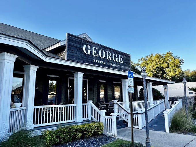 The striking contrast of black signage against white columns creates that perfect first impression – sophisticated yet approachable, like a tuxedo with flip-flops.