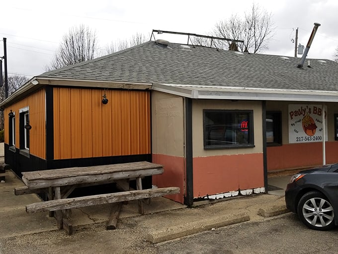 The original Pauly's location might look humble, but that wooden picnic bench has hosted more BBQ dreams than most five-star restaurants.