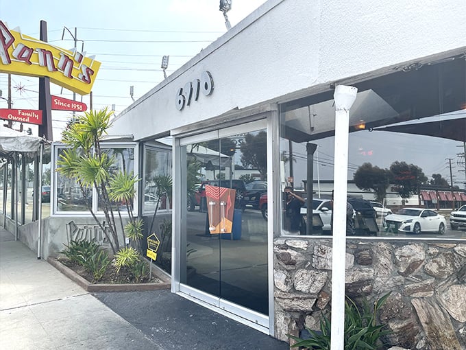 The iconic Pann's exterior beckons with mid-century charm and that unmistakable neon sign – architectural eye candy that promises delicious comfort inside.