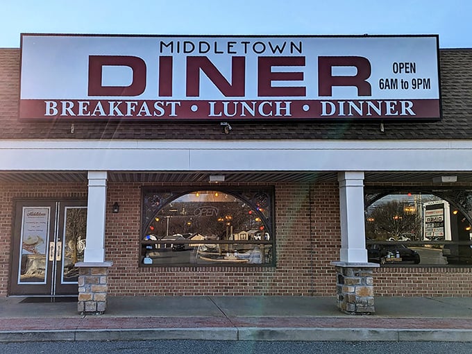 The iconic red lettering of Middletown Diner stands like a beacon of breakfast hope against the Delaware sky. Open 6AM to 9PM for all your comfort food cravings.