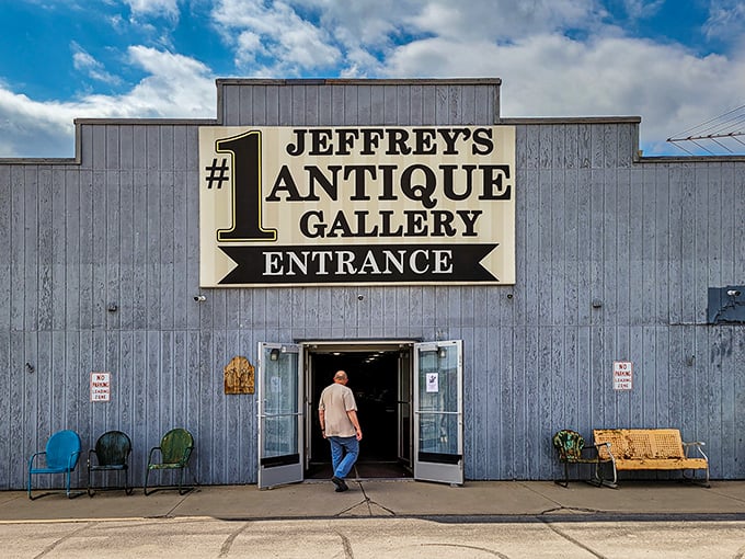 The unassuming entrance to Jeffrey's Antique Gallery beckons with vintage chairs outside – a humble preview of the wonderland waiting within.