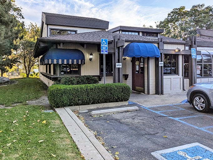 A classic California steakhouse facade that whispers rather than shouts—those blue awnings are like a secret handshake among steak aficionados.