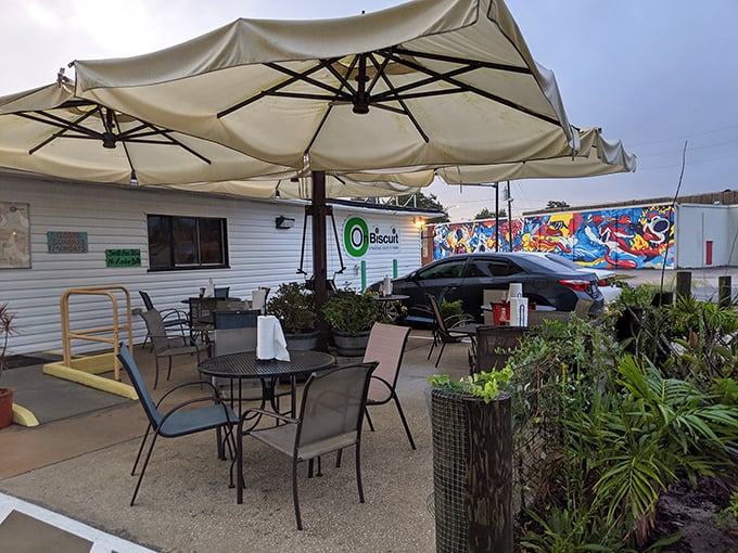 Outdoor seating under canvas umbrellas offers Florida sunshine with your breakfast. The colorful mural adds artistic flair to your morning ritual.