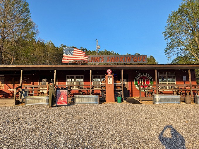 The American flag proudly waves above this rustic BBQ haven, promising patriotic flavors that'll have you pledging allegiance to slow-smoked goodness.