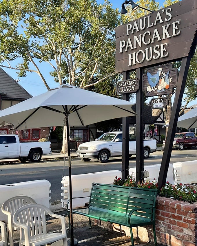 The wooden sign beckons like an old friend – Paula's Pancake House, where breakfast dreams come true under California sunshine and Danish-inspired charm.
