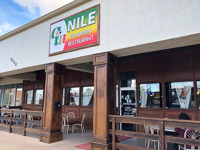 The unassuming storefront of Nile Ethiopian beckons like a culinary oasis in Orlando. Those wooden pillars aren't just supporting the roof—they're holding up flavor heaven.