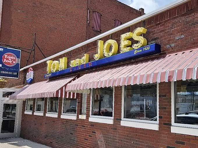 That red and white awning isn't just decoration—it's a portal to a simpler time when diners served community alongside comfort food.