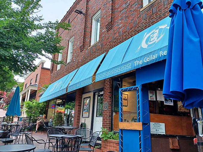 The iconic blue awning of The Cellar Restaurant stands out against Blacksburg's brick backdrop like a Mediterranean oasis in Hokie country.