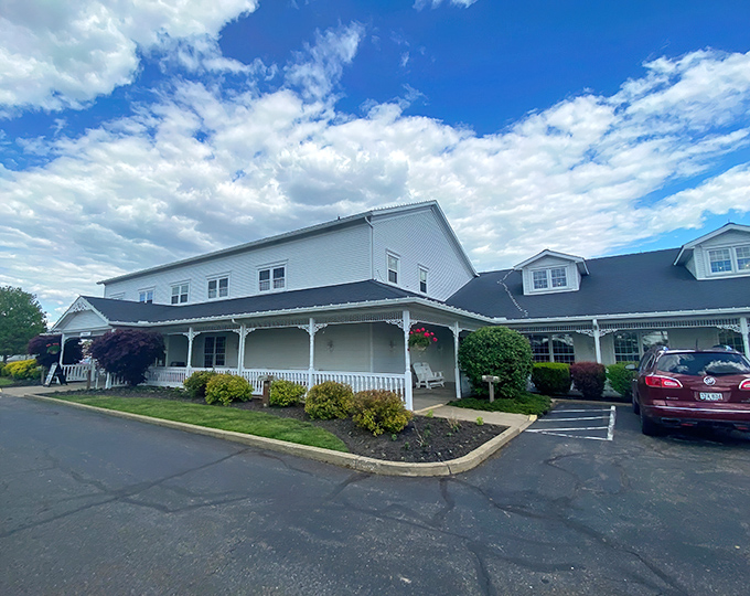The Amish Door's classic white farmhouse exterior stands proudly against Ohio's blue sky, promising comfort food that'll make your soul sing and your belt loosen.