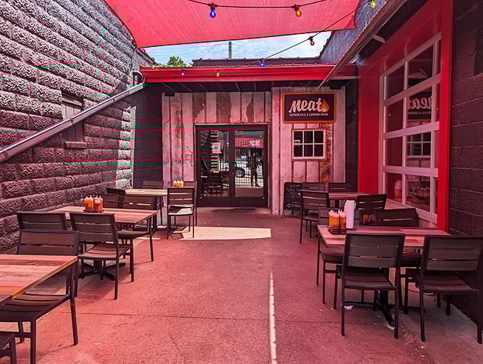 Outdoor dining nirvana awaits under a canopy of red with simple wooden tables – because fancy furniture would just distract from the main event: the meat.