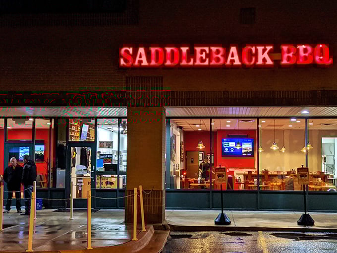 By night, the neon-red glow transforms this strip mall spot into a beacon of barbecue hope, drawing in carnivores like moths to a delicious flame.