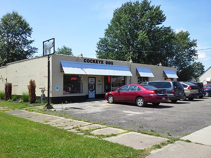 The unassuming exterior of Cockeye BBQ proves once again that the best food often hides behind the simplest facades. Smoke signals of deliciousness await inside.