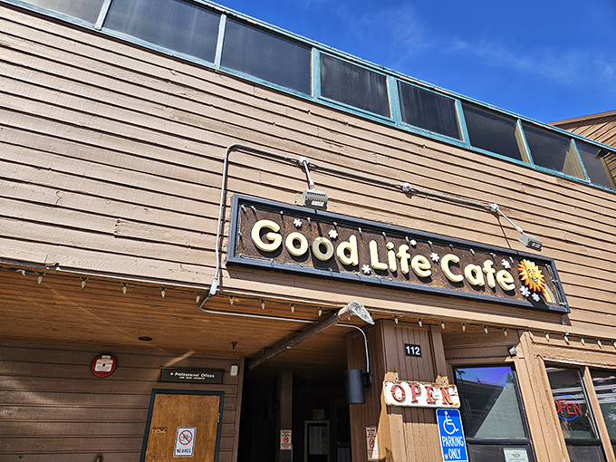 The unassuming wooden exterior of Good Life Cafe proves once again that culinary treasures often hide in plain sight. That sunflower sign promises warmth inside!
