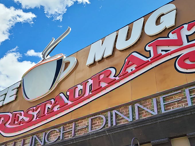 The iconic Coffee Mug sign beckons hungry travelers like a desert oasis, promising comfort food salvation on Elko's main drag.