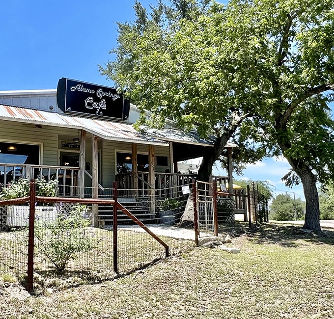 The quintessential Texas Hill Country hideaway – rustic charm under shade trees with a metal roof that's weathered more stories than a country song.
