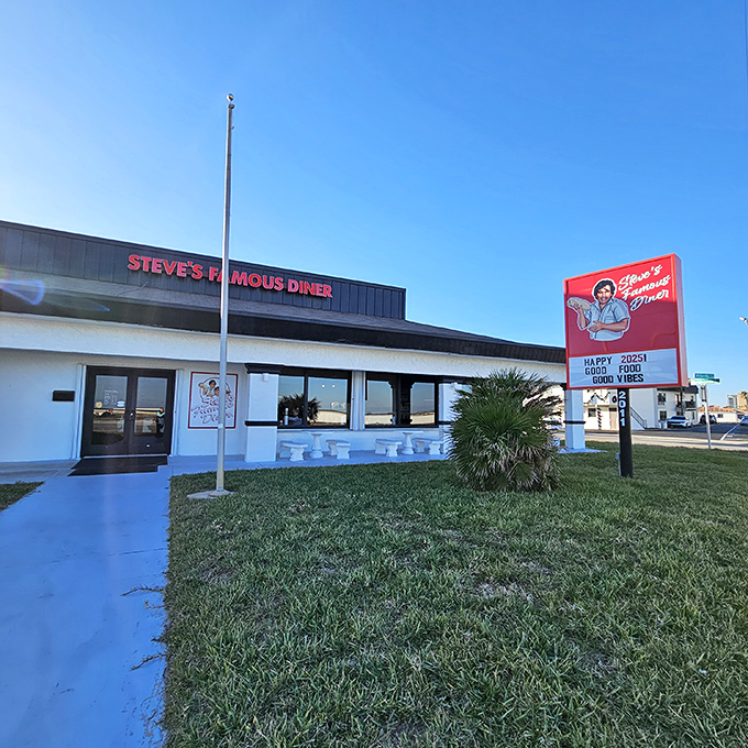 Steve's Famous Diner stands proudly against the Florida sky, its red sign promising "Happy Food, Good Vibes" – a roadside beacon for hungry travelers.