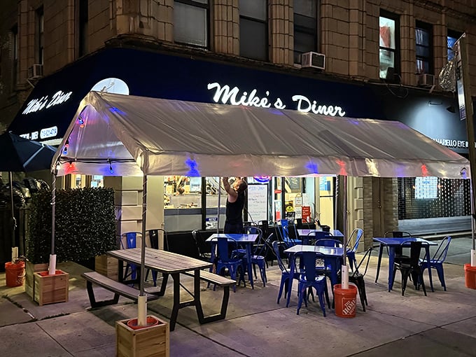 That iconic blue awning isn't just a canopy—it's a beacon of breakfast hope on a Brooklyn corner, promising Greek-American comfort under twinkling outdoor lights.