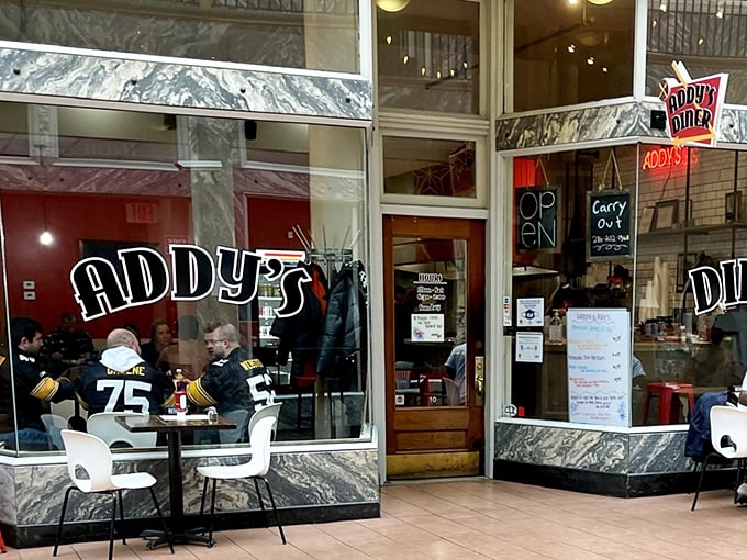 Addy's classic storefront beckons with marble accents and neon signage—like a time portal to when breakfast was an art form, not just a meal.