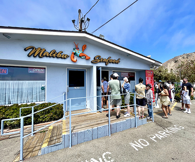 The unassuming white building with that iconic lobster sign promises seafood paradise. No fancy frills, just the real deal.