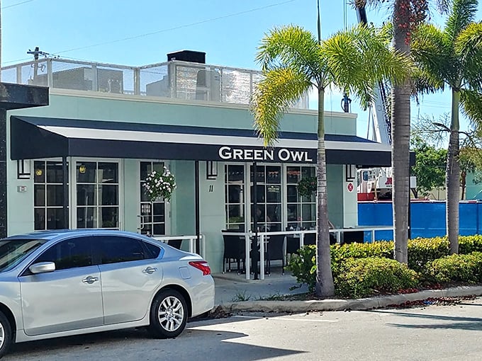 The mint-green exterior of Green Owl stands like a culinary lighthouse amid Delray's palms, promising breakfast treasures for those in the know.