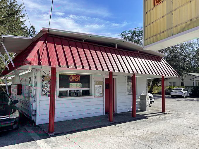 The red-and-white awning isn't just decoration—it's a beacon for fried chicken pilgrims. This humble shack houses flavor that puts fancy restaurants to shame.