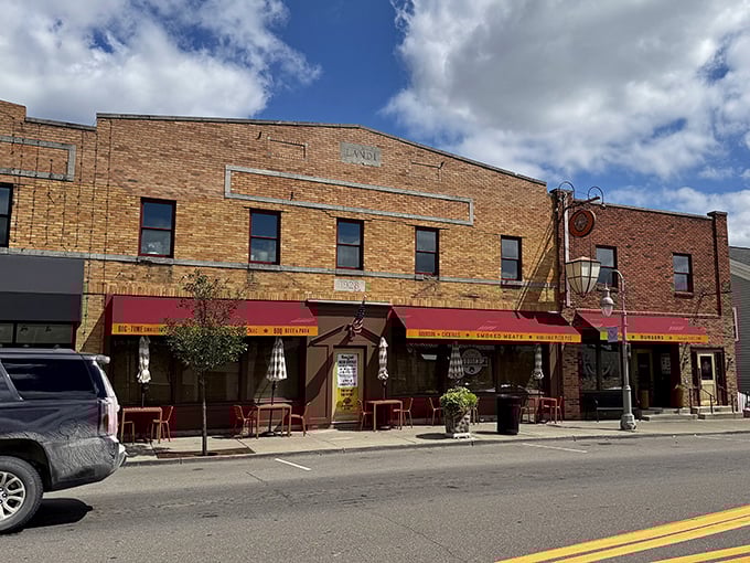 The brick façade of Union Woodshop stands proudly on Clarkston's Main Street, its red awnings like welcome flags beckoning hungry travelers to barbecue paradise.