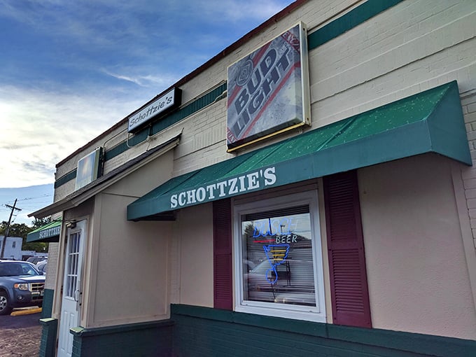 The unassuming exterior of Schottzie's, with its classic green awning, proves once again that culinary adventures often hide behind the most modest facades.