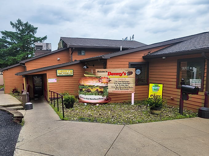 The legendary burger monument outside Denny's Beer Barrel Pub announces your arrival to burger paradise. This isn't just signage—it's a warning of the delicious challenges that await inside.