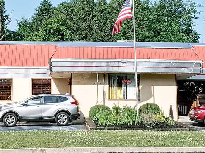 The humble exterior with its red roof and American flag promises no pretension—just honest food that speaks volumes about Pennsylvania's culinary soul.