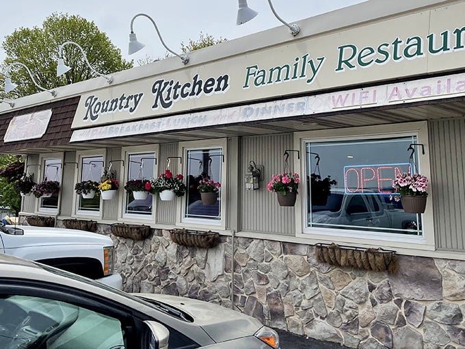 Classic Pennsylvania charm on display—stone foundation, cream siding, and those cheerful hanging baskets that say "come on in, we've got something good cooking."