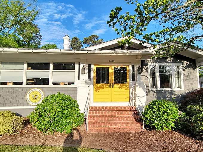 Those sunshine-yellow doors aren't just an entrance—they're a promise of the golden, buttery biscuits waiting inside this charming Pungo cottage.