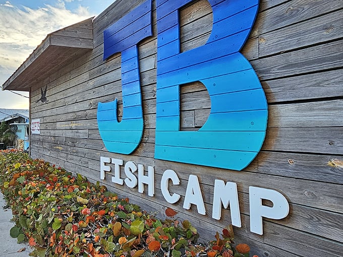 That iconic blue sign against weathered wood says it all – you've arrived somewhere authentic, where the seafood is fresh and pretension is left at the door.