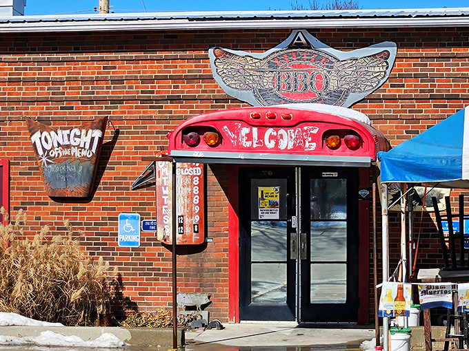 The winged BBQ logo above the entrance isn't just decoration—it's a promise that your taste buds are about to take flight at this unassuming brick building.