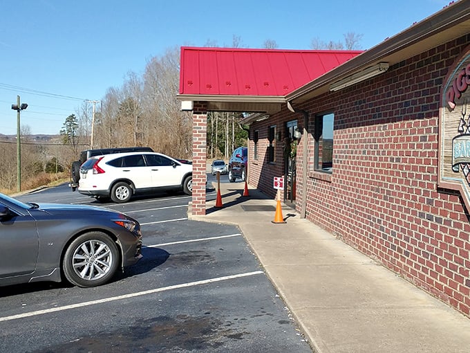 That iconic red roof is like a beacon for hungry travelers. Brick exterior says "no-nonsense" while secretly promising life-changing barbecue inside. 