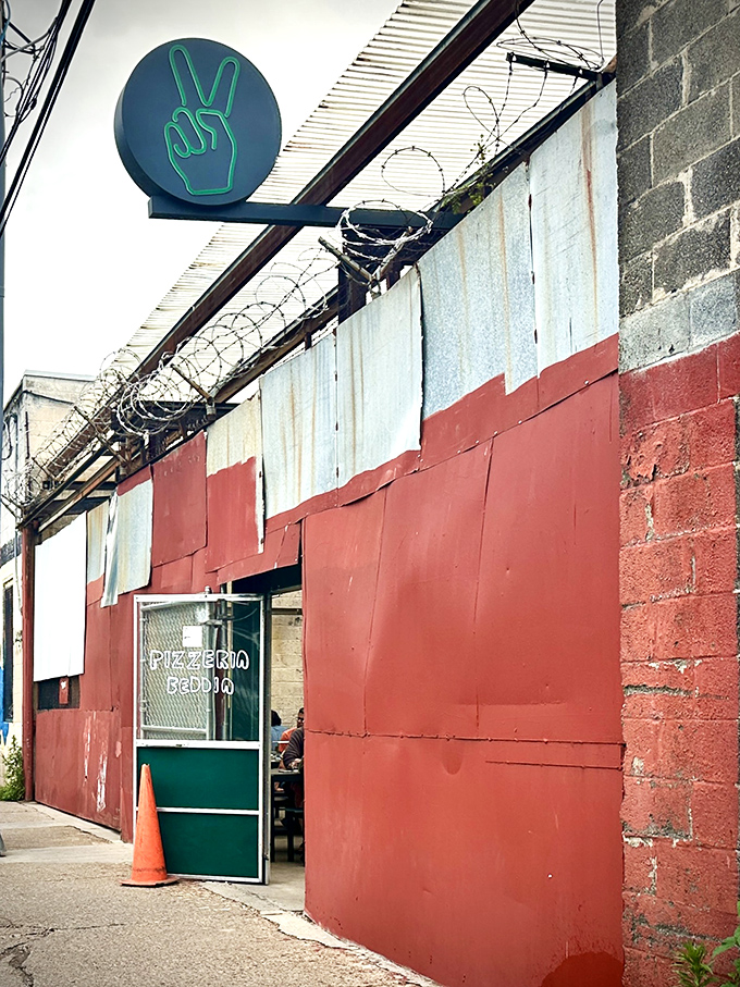 The iconic green peace sign beckons pizza pilgrims to this unassuming Fishtown gem. Proof that greatness often hides behind humble facades.