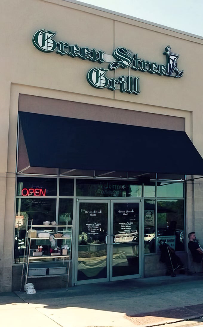 The unassuming exterior of Green Street Grill beckons with its classic green awning and glowing "OPEN" sign – a culinary treasure hiding in plain sight.