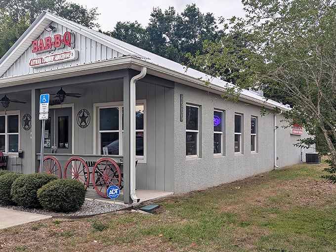 The unassuming exterior of Artman Country Smokehouse beckons with rustic charm. Those wagon wheels aren't just decoration—they're a promise of old-fashioned barbecue goodness waiting inside.