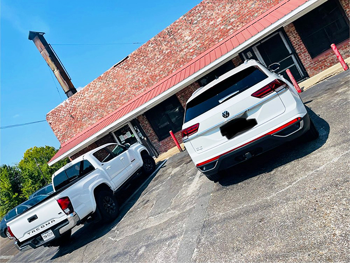 The unassuming brick exterior of E&L Barbeque—where culinary magic happens behind walls that have absorbed decades of heavenly smoke.