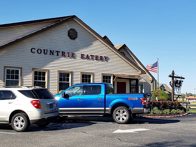The Countrie Eatery stands proudly against a blue Delaware sky, its cream clapboard exterior promising comfort food treasures within.